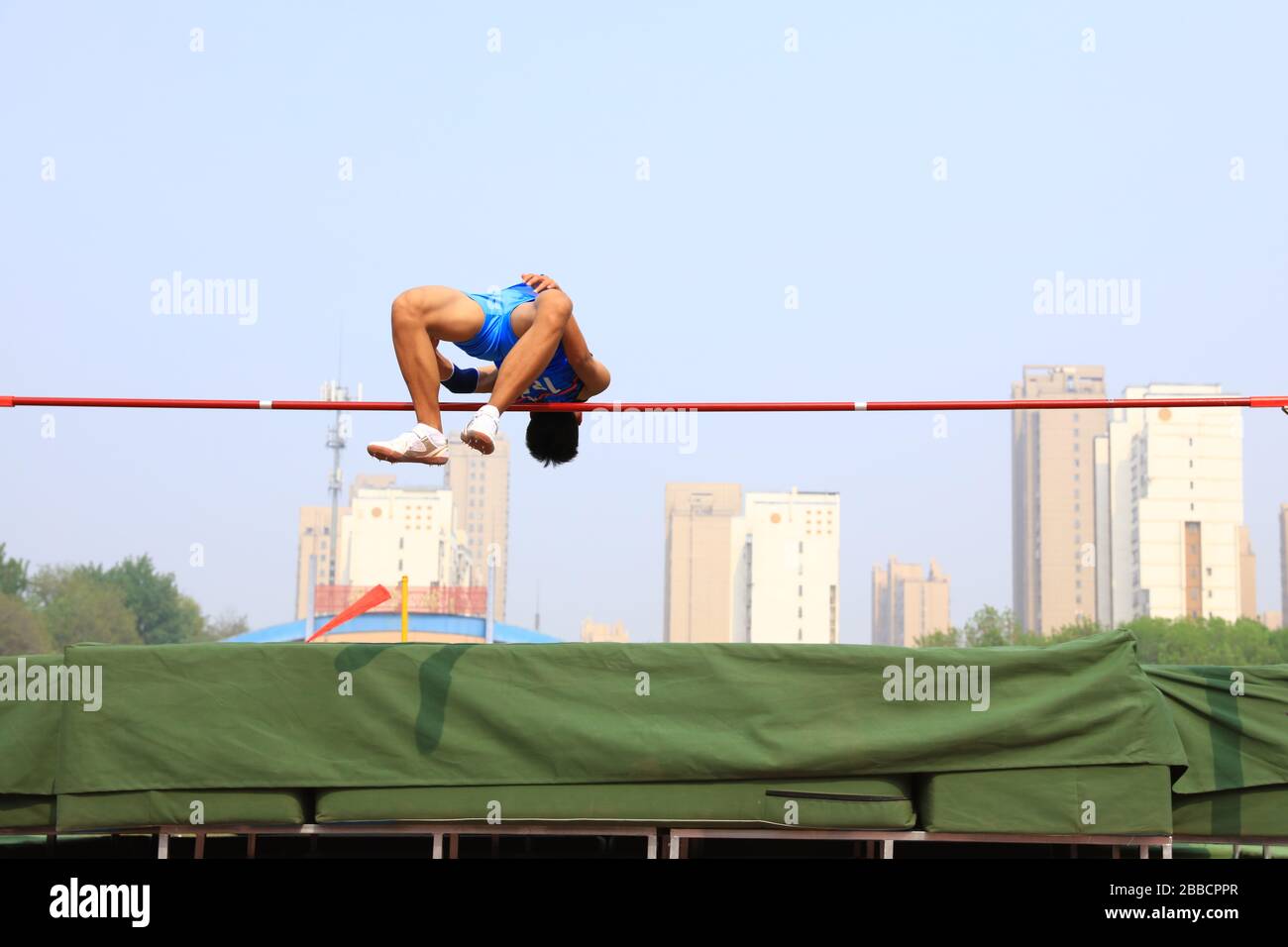 A male athlete is on the high jump Stock Photo - Alamy