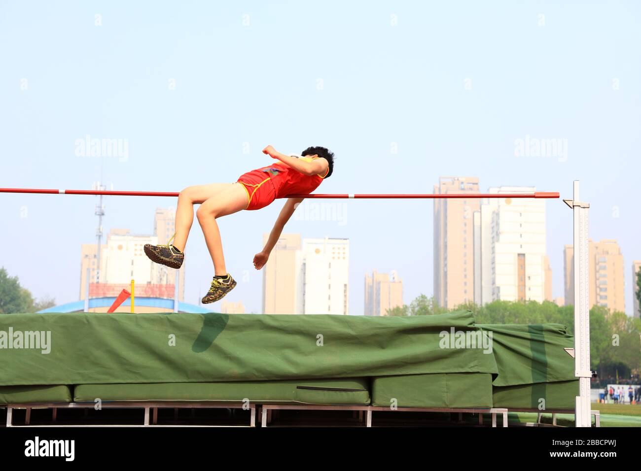 A male athlete is on the high jump Stock Photo - Alamy