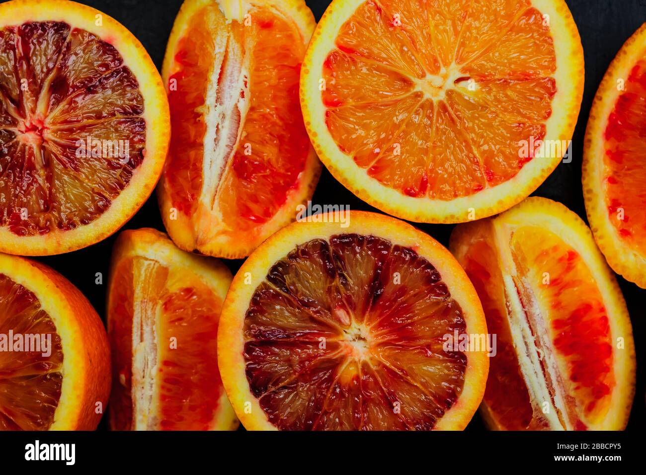 Top view of fresh blood orange halves and quaters. Fruit background ...