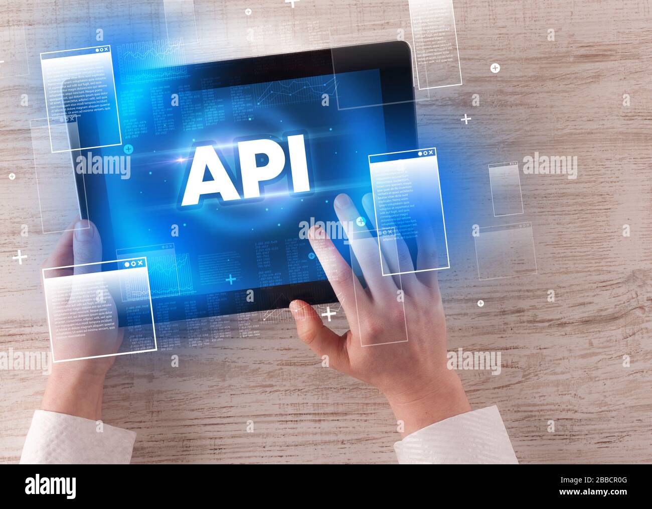 Close-up of a hand holding tablet with API abbreviation, modern ...