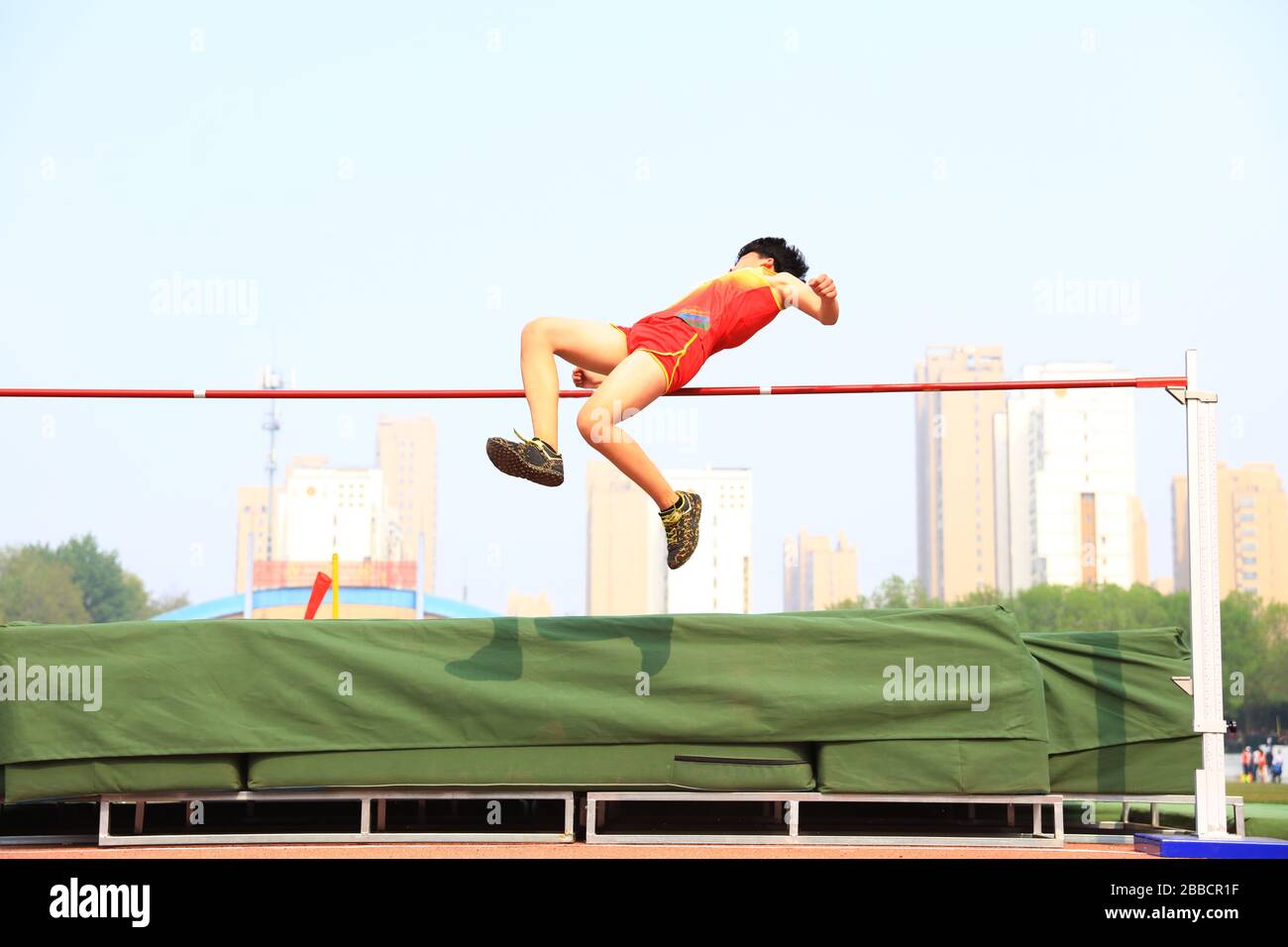 A male athlete is on the high jump Stock Photo - Alamy