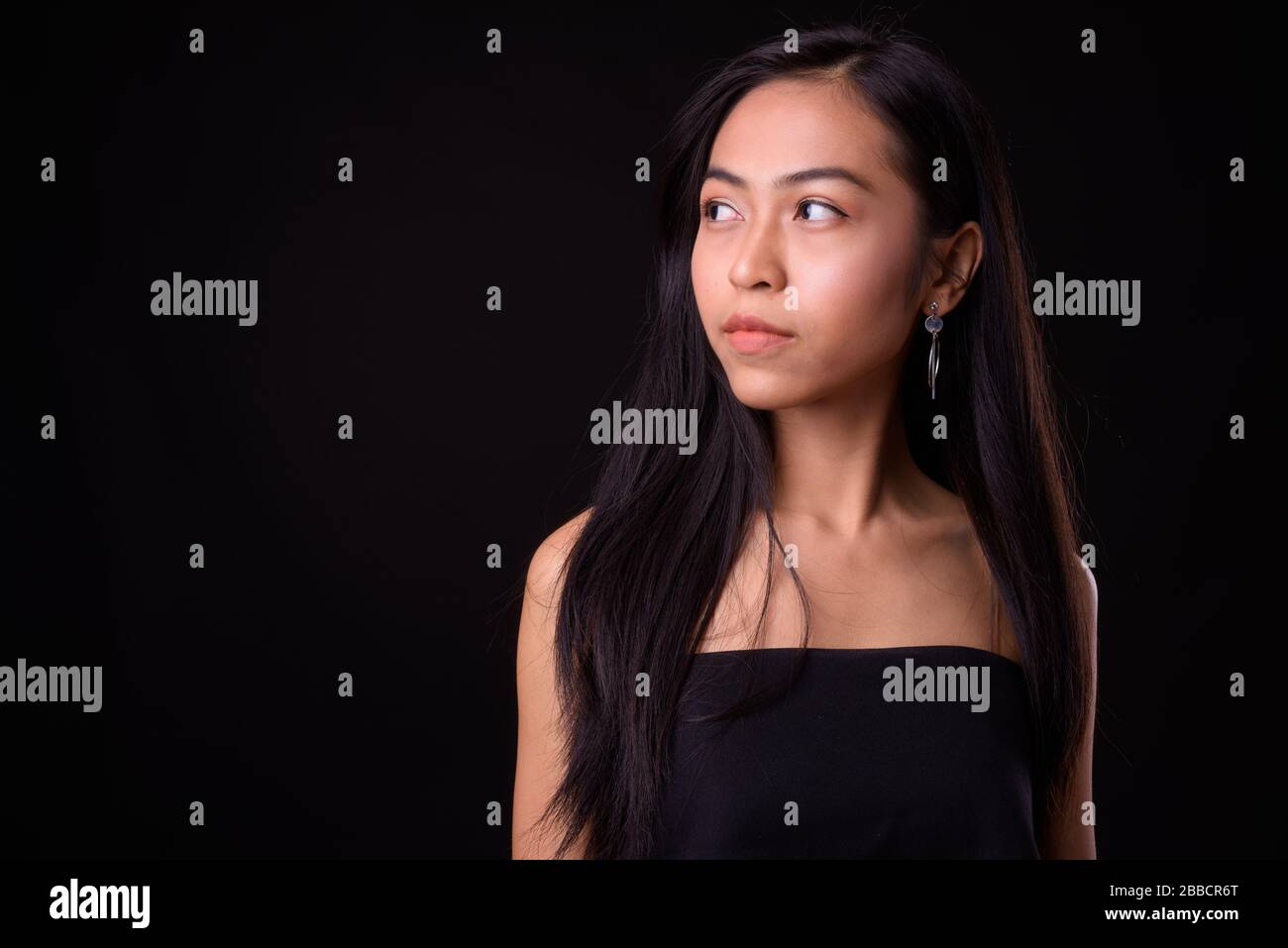 Face of young beautiful Asian woman thinking Stock Photo - Alamy