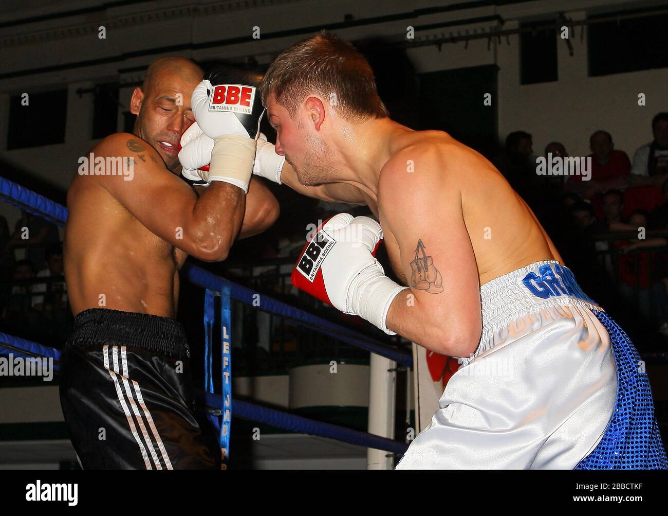 John Wayne Hibbert (blue/white shorts) defeats Rick Boulter in a Light-Welterweight boxing ...