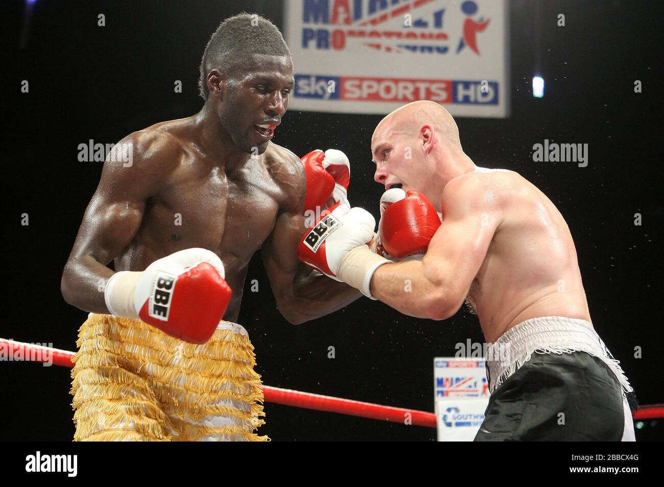 Menay Edwards (gold shorts) defeats Carl Wild in a Light-Heavyweight ...
