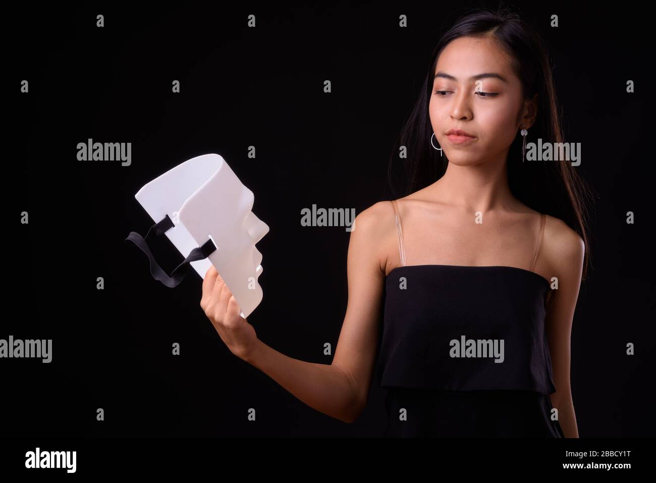 Portrait of young beautiful Asian woman looking at mask Stock Photo - Alamy