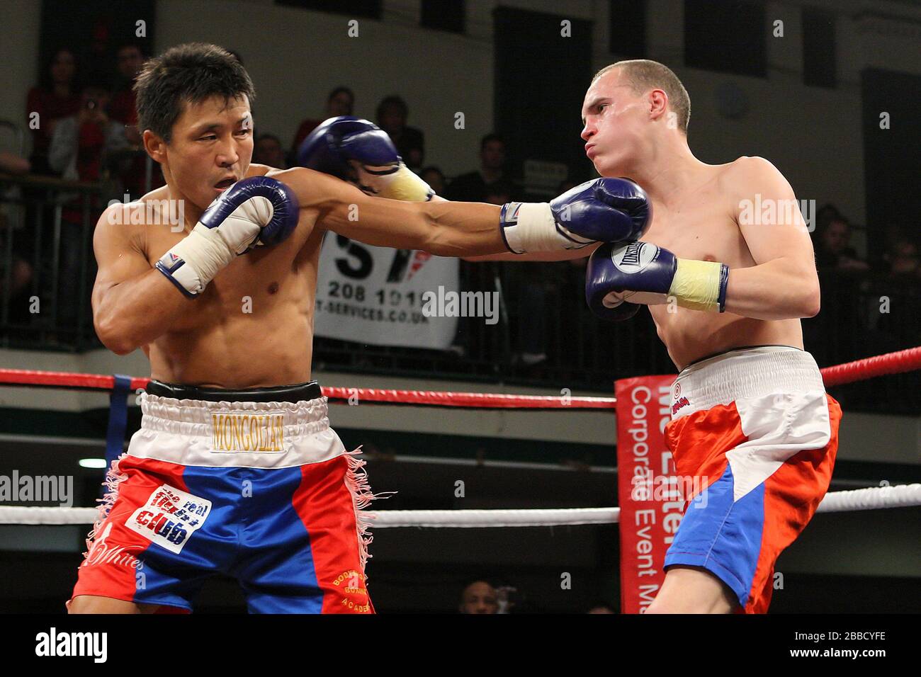 Choi Tseveenpurev (red/blue shorts) defeats Janis Purkins in a ...