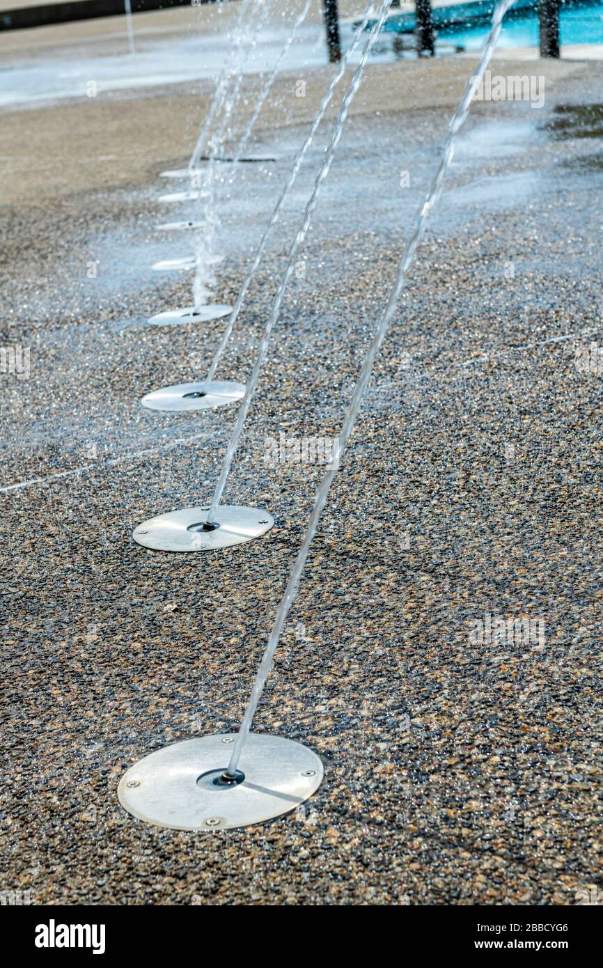 Water jets on the sidewalk of a city Stock Photo - Alamy
