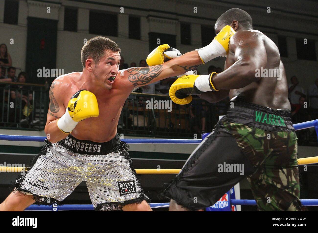 Tony Conquest (silver shorts) defeats Hastings Rasani (camouflage ...