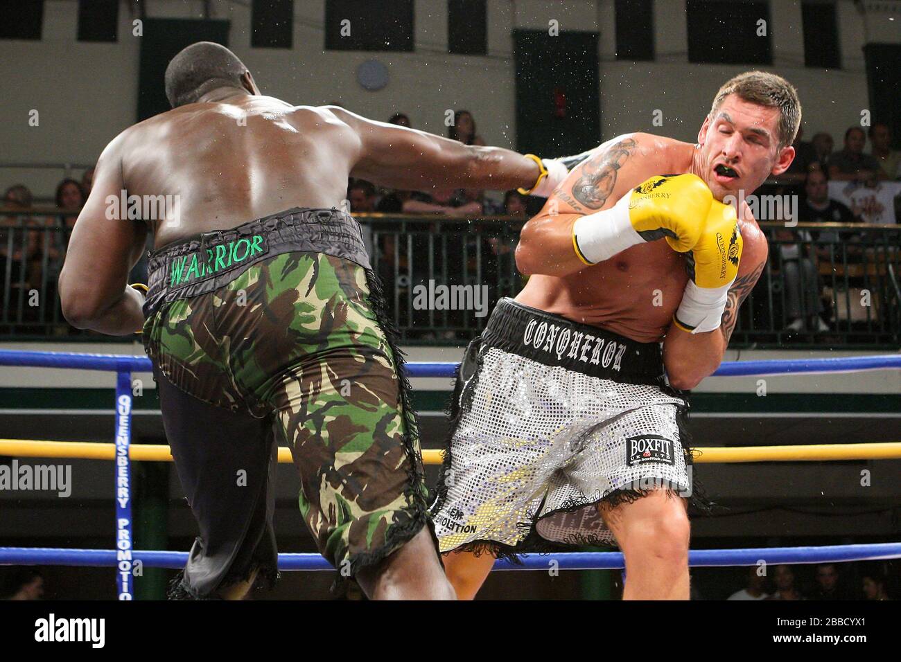 Tony Conquest (silver shorts) defeats Hastings Rasani (camouflage ...