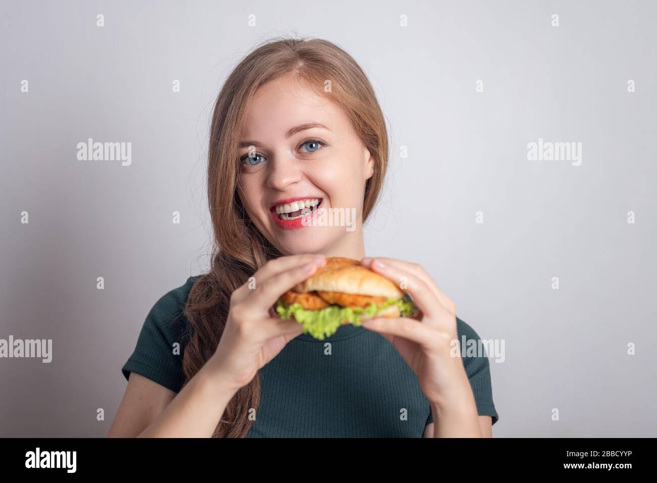 Attractive woman eating burger hi-res stock photography and images - Alamy