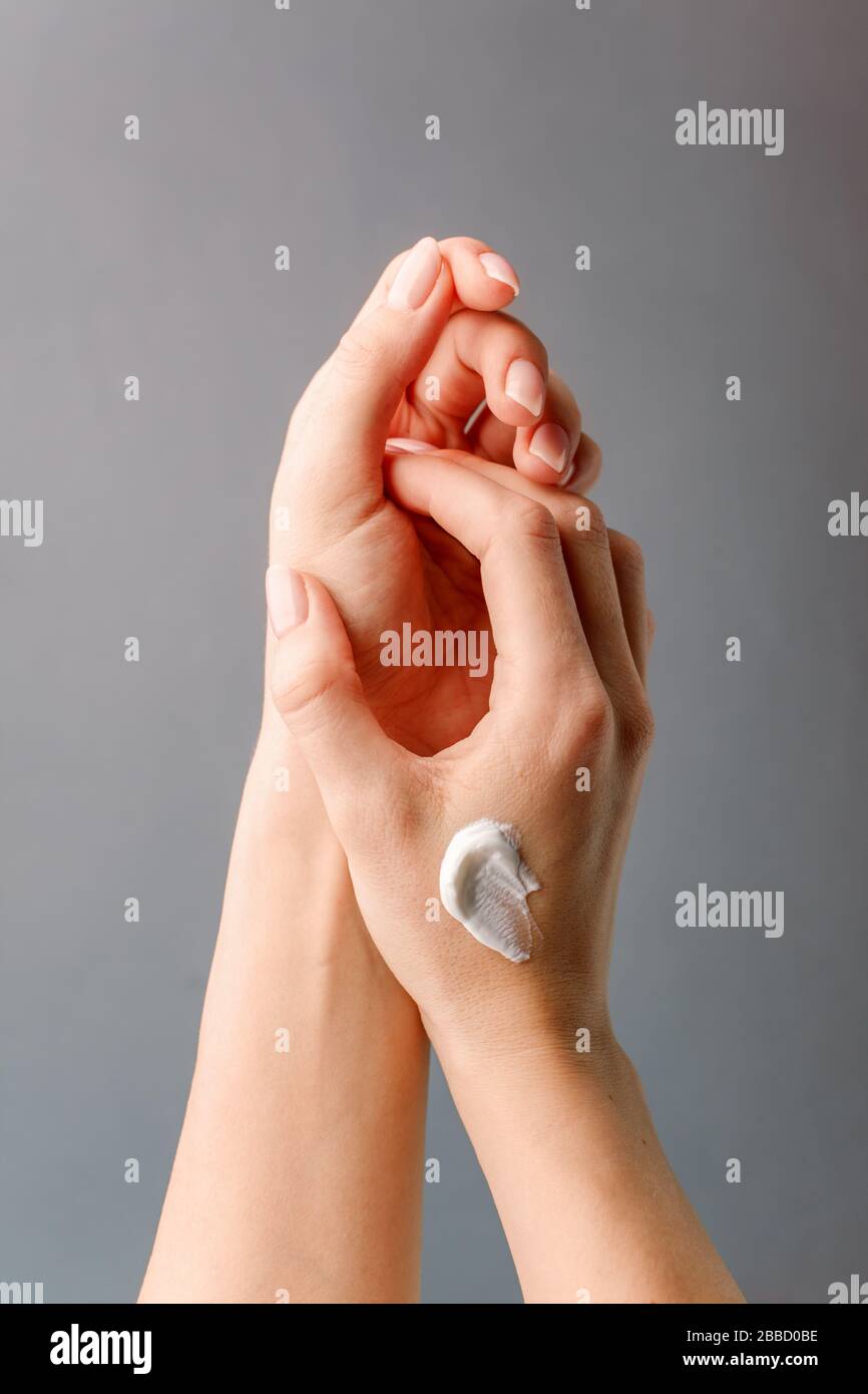 Closeup on woman's hands applying moisturizing hand-cream on, minimal ...