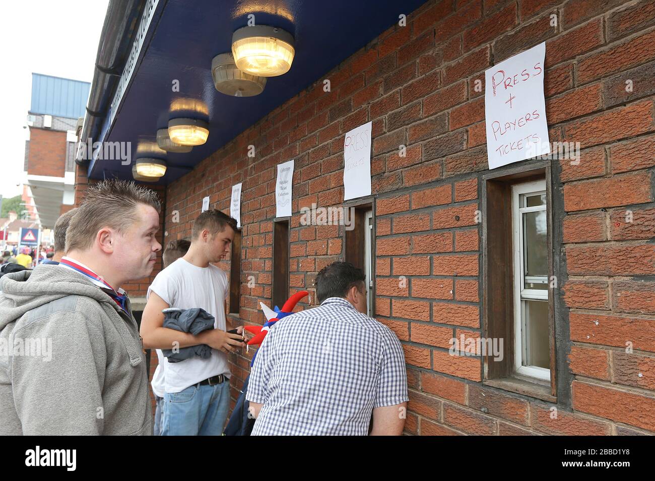 Fans queue at the ticket office outside Selhurst Park before the match ...
