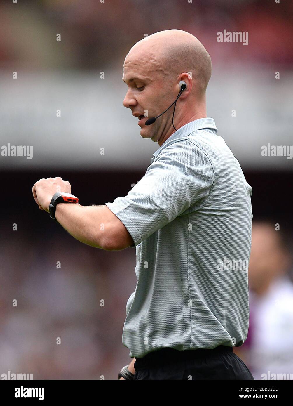Referee Anthony Taylor looks at his goal line technology watch Stock ...