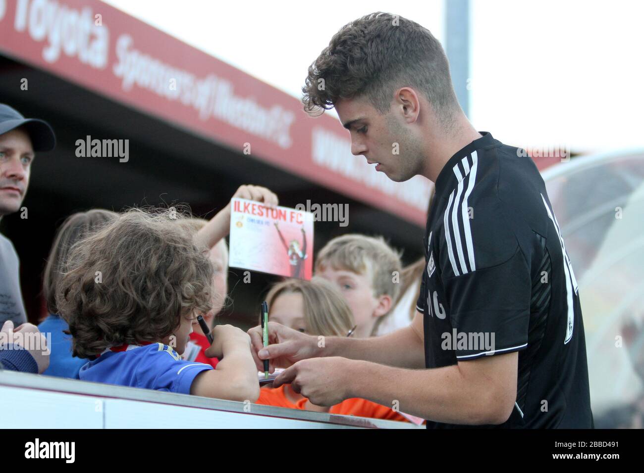 Chelsea's Dion Conroy signs a programme for a young fan Stock Photo - Alamy
