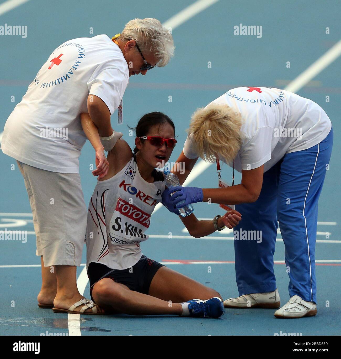 Hye-Song Kim of Korea is helped from the track after the marathon ...