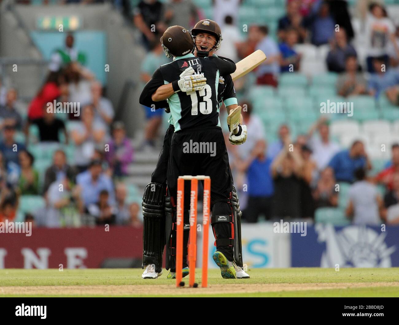Surrey's Jon Lewis (facing) and Gareth Batty celebrate scoring the ...
