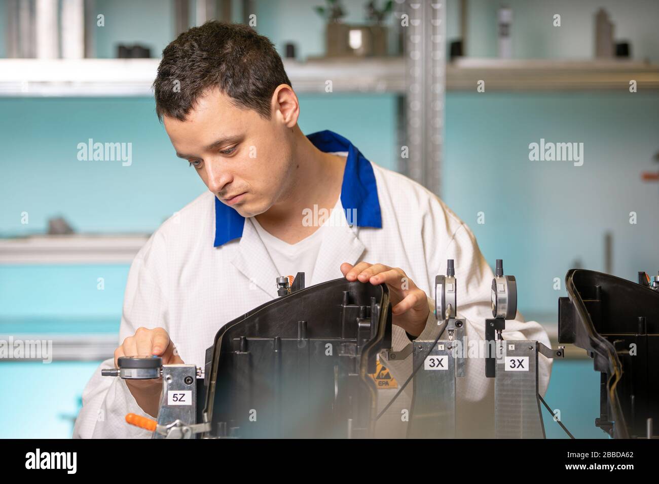 Automotive. Quality Engineer performs measurement of plastic casting ...