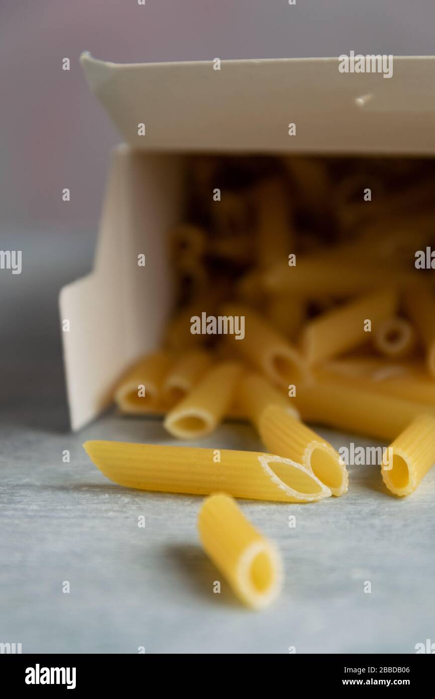 Food background - dry penne pasta, whole wheat uncooked ingredient ...
