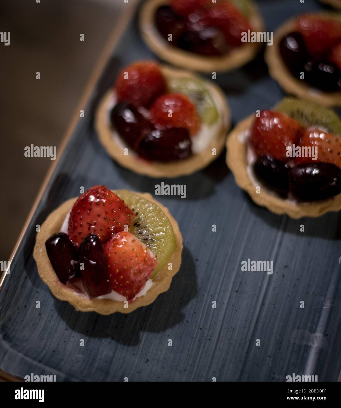 Delicious and tasty pieces of tart cakes garnished with fresh fruits ...