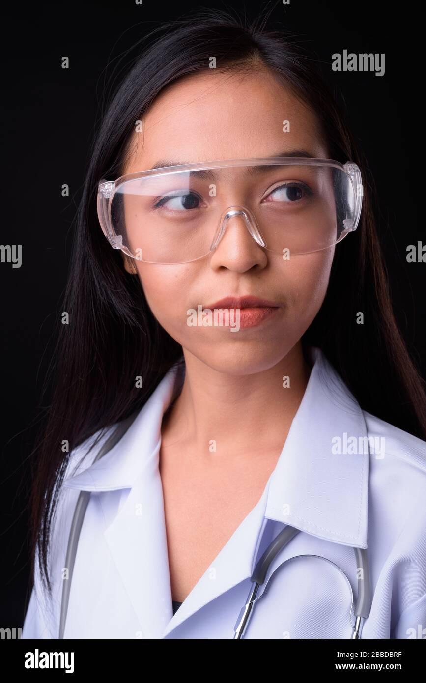 Face of young Asian woman doctor as scientist thinking Stock Photo - Alamy