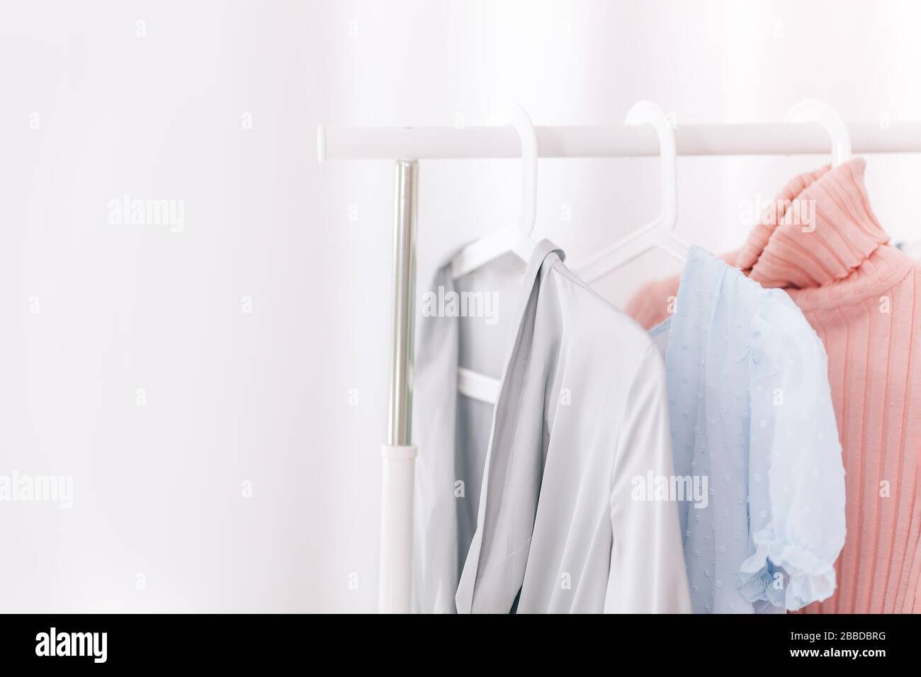 clothes hanging on hangers Stock Photo - Alamy