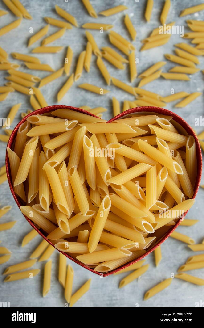 Food background - dry penne pasta, whole wheat uncooked ingredient ...