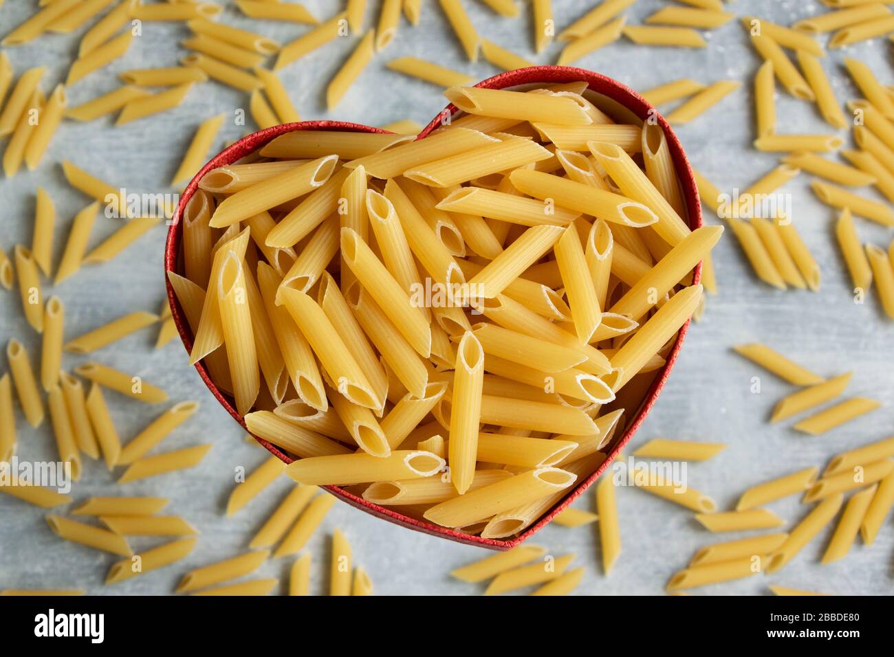 Food background - dry penne pasta, whole wheat uncooked ingredient ...
