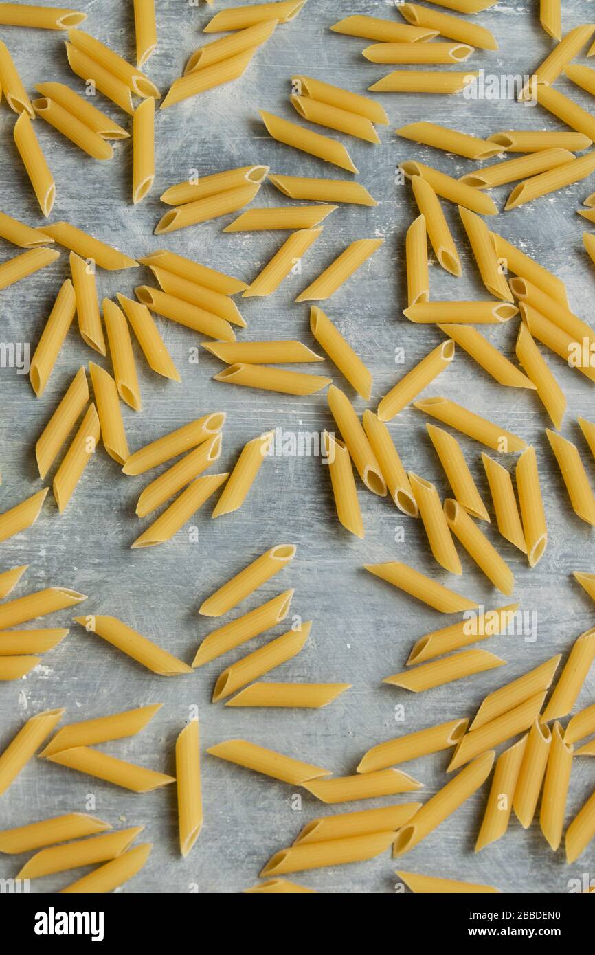 Food background - dry penne pasta, whole wheat uncooked ingredient ...