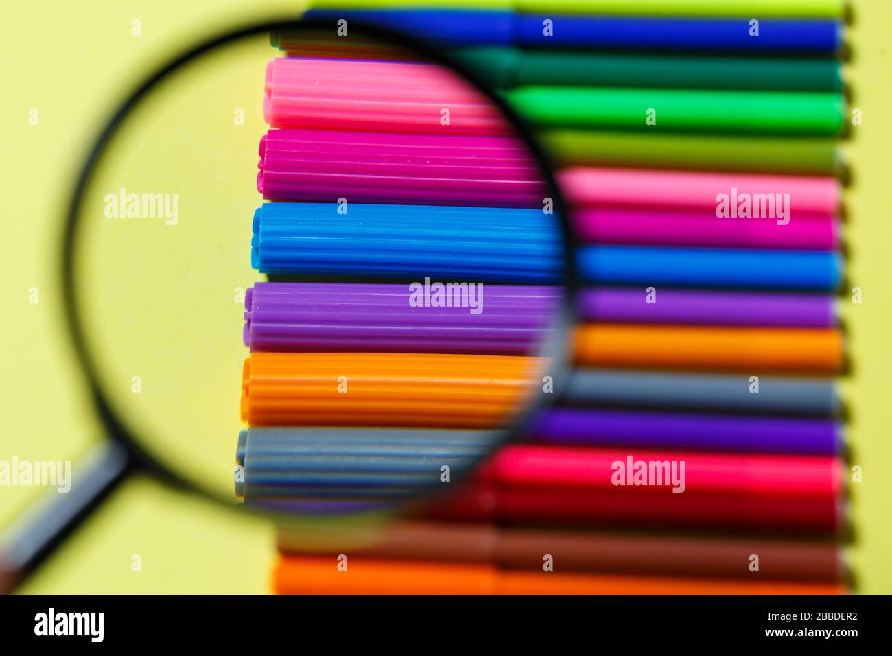 multi-colored markers for drawing through a magnifying glass on a ...