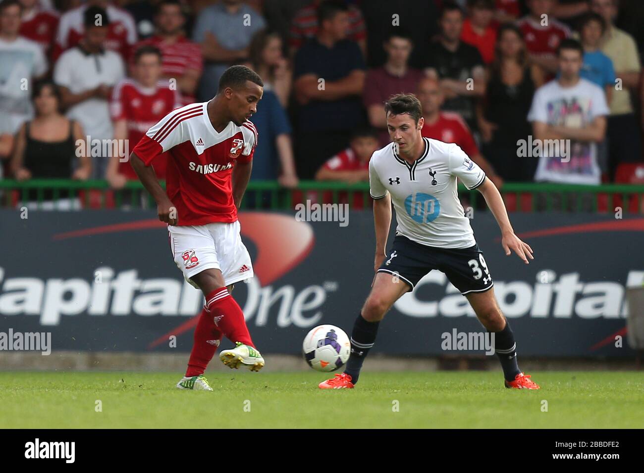 Swindon Town's Nathan Byrne runs at Tottenham Hotspur's Adam Smith ...