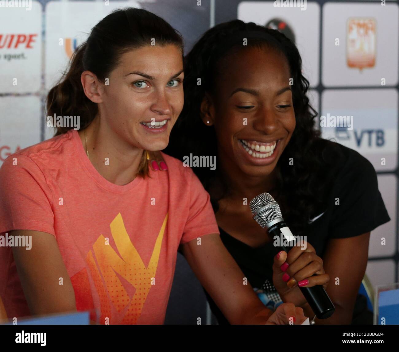 Russia's Anna Chicherova (left) and USA's Brigetta Barrett sing a song ...