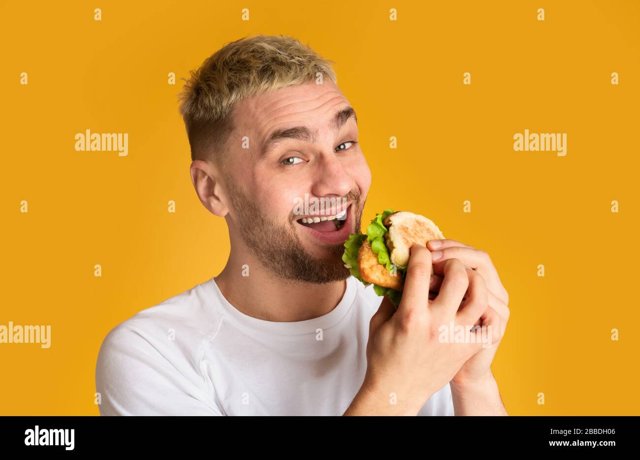 Ridiculous cute man loves fast food, free space Stock Photo - Alamy