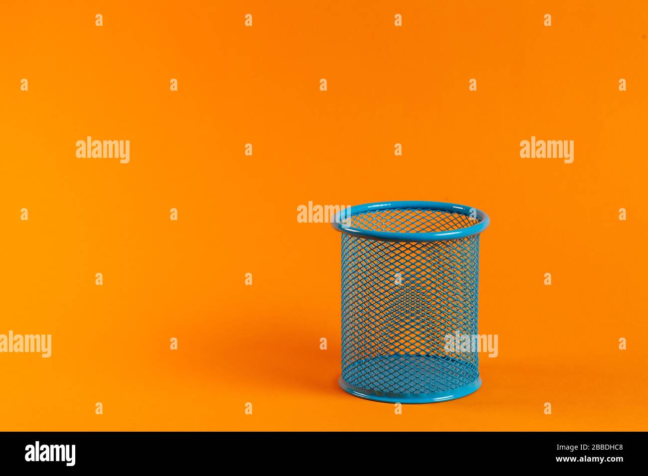 blue metal bucket for office on an orange background Stock Photo - Alamy