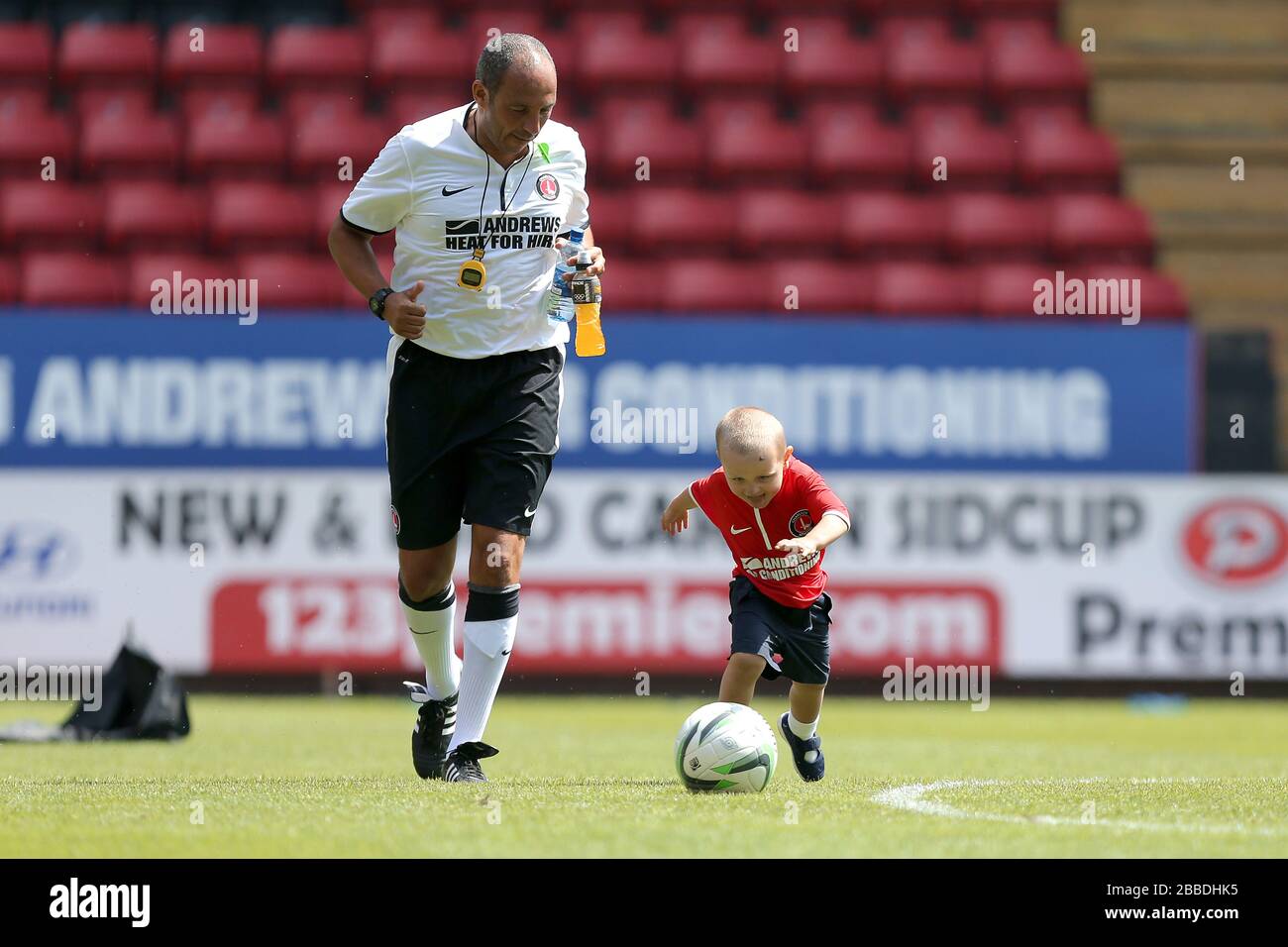 Charlton Athletic first team coach Damian Matthew with a young fan ...
