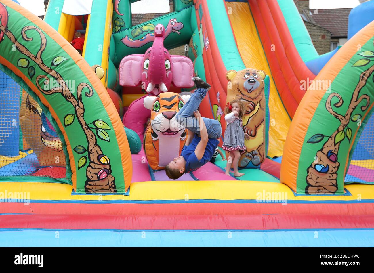 Children enjoy inflatables outside The Valley Stock Photo - Alamy