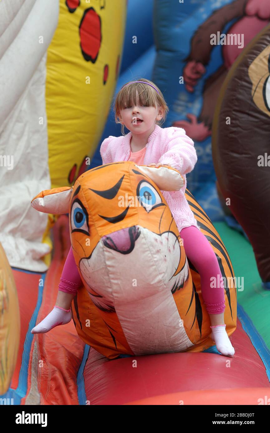Children enjoy inflatables outside The Valley Stock Photo - Alamy