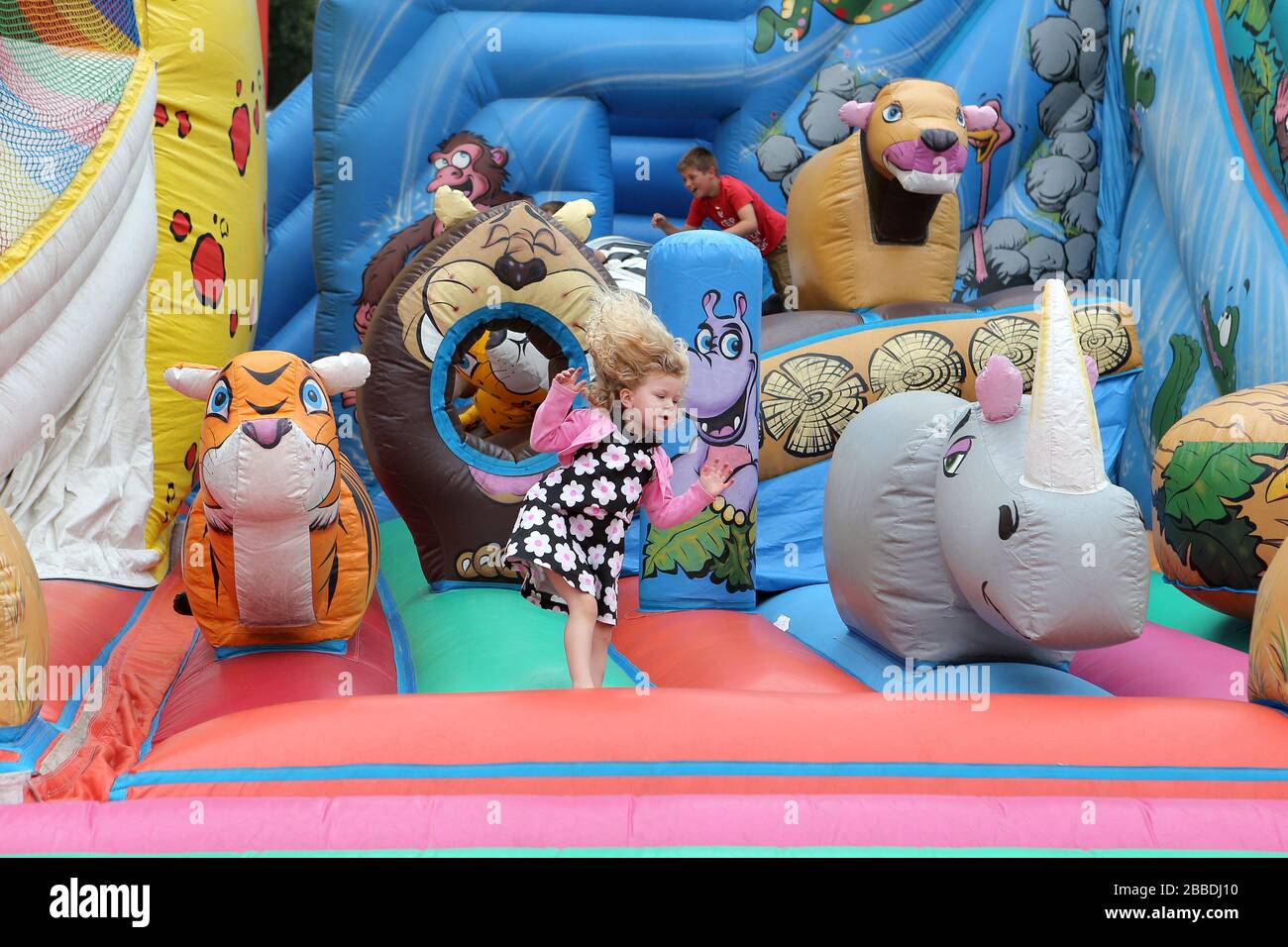 Children enjoy inflatables outside The Valley Stock Photo - Alamy