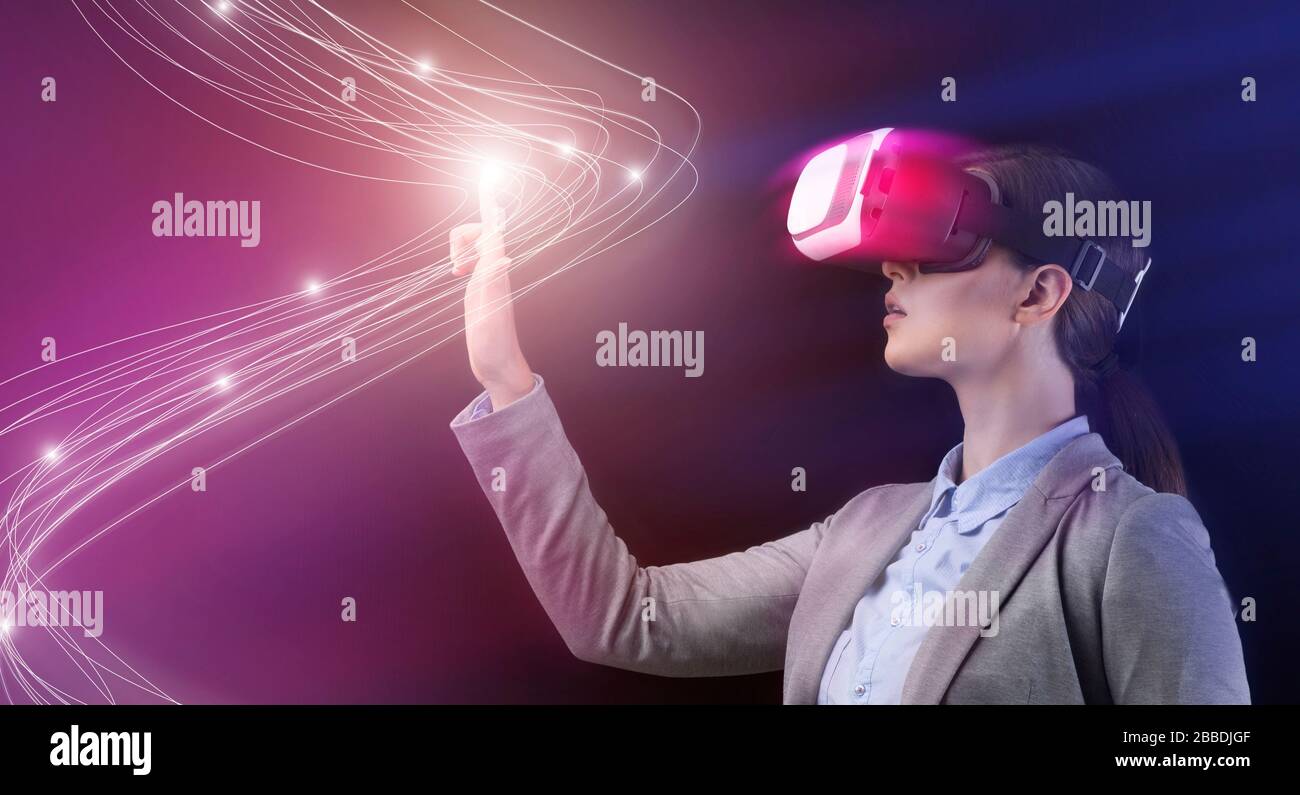 Innovative technologies. Businesswoman in VR headset pressing button on ...