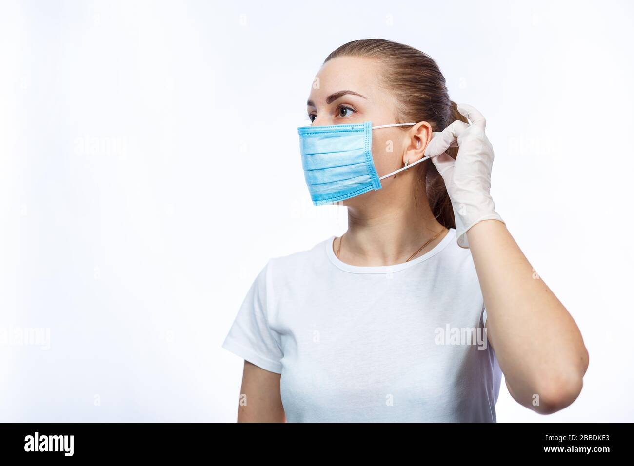 woman health worker demonstrates how to wear a protective medical ...