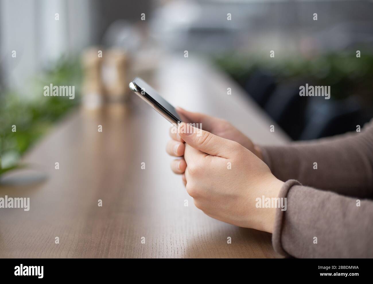 Female hands leaning on the bar counter and text messaging Stock Photo ...