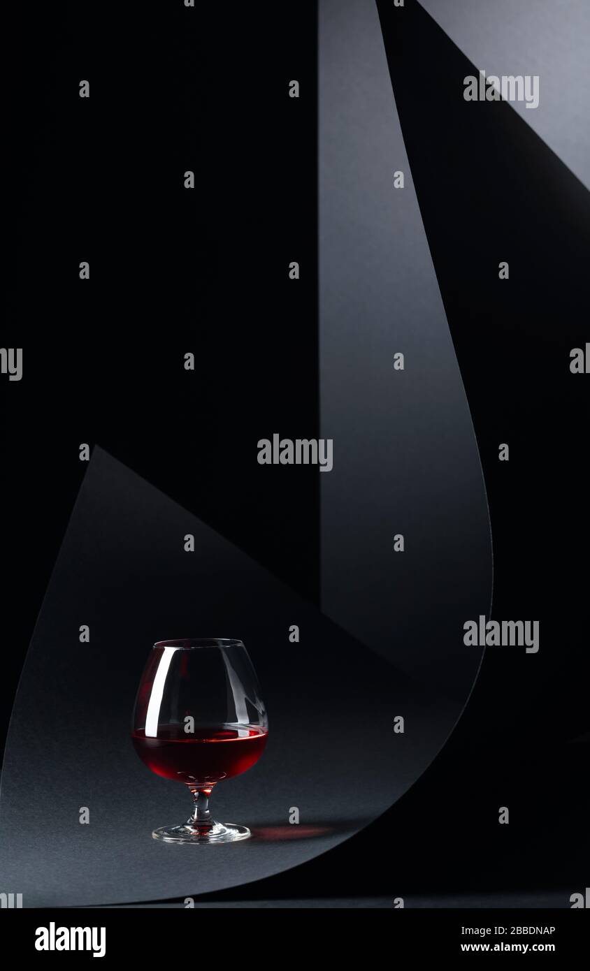 Glass of brandy on a black background. Copy space Stock Photo - Alamy