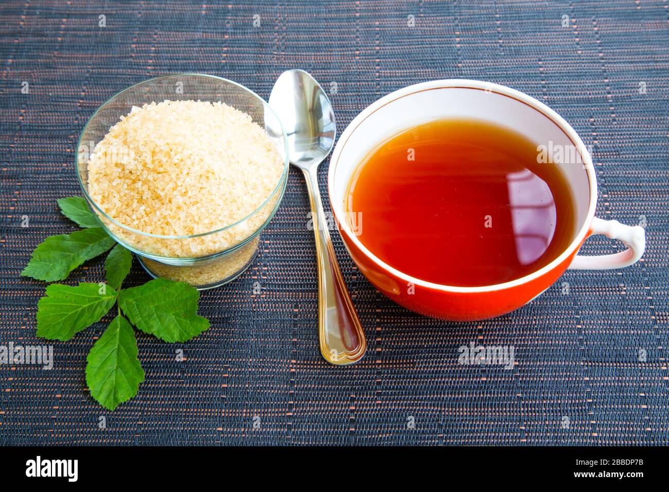 Cup of tea and brown sugar on a white background Stock Photo - Alamy