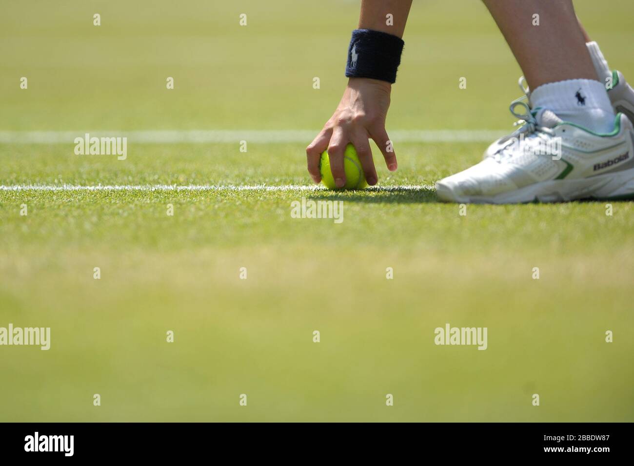 Ball boy picks up tennis ball off the court hi-res stock photography ...