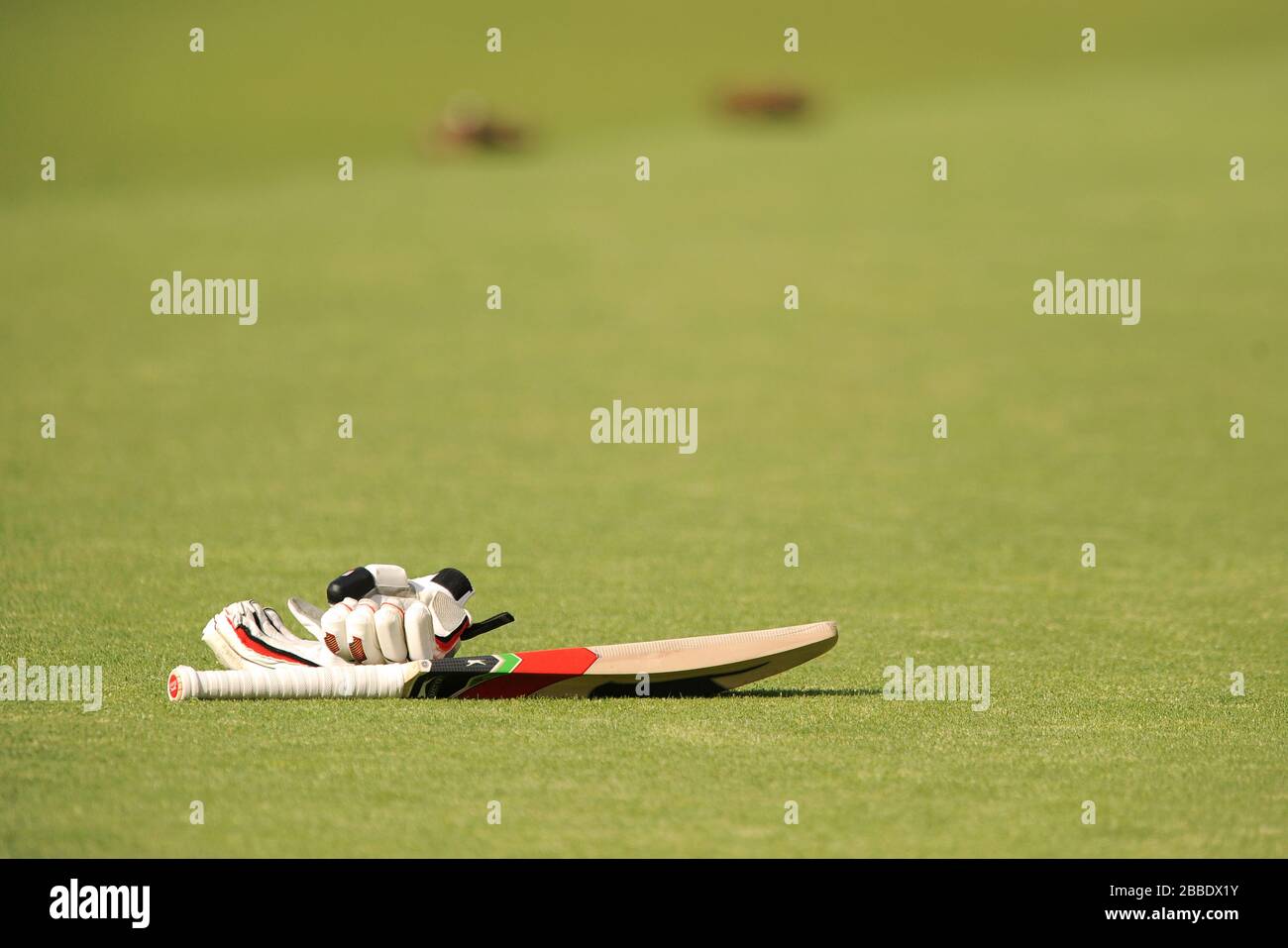 A cricket bat and gloves during warm up Stock Photo - Alamy