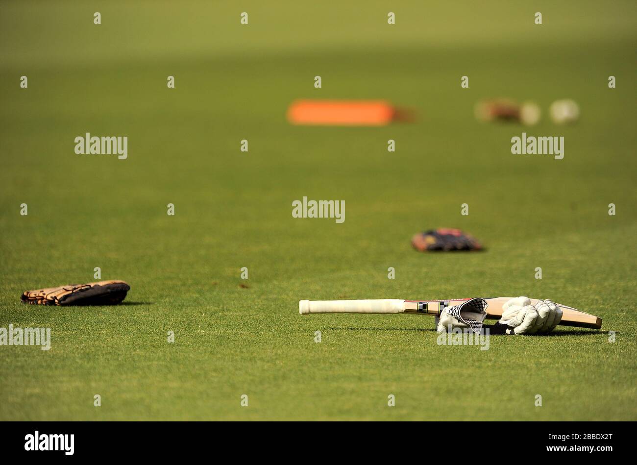 A cricket bat and gloves during warm up Stock Photo - Alamy