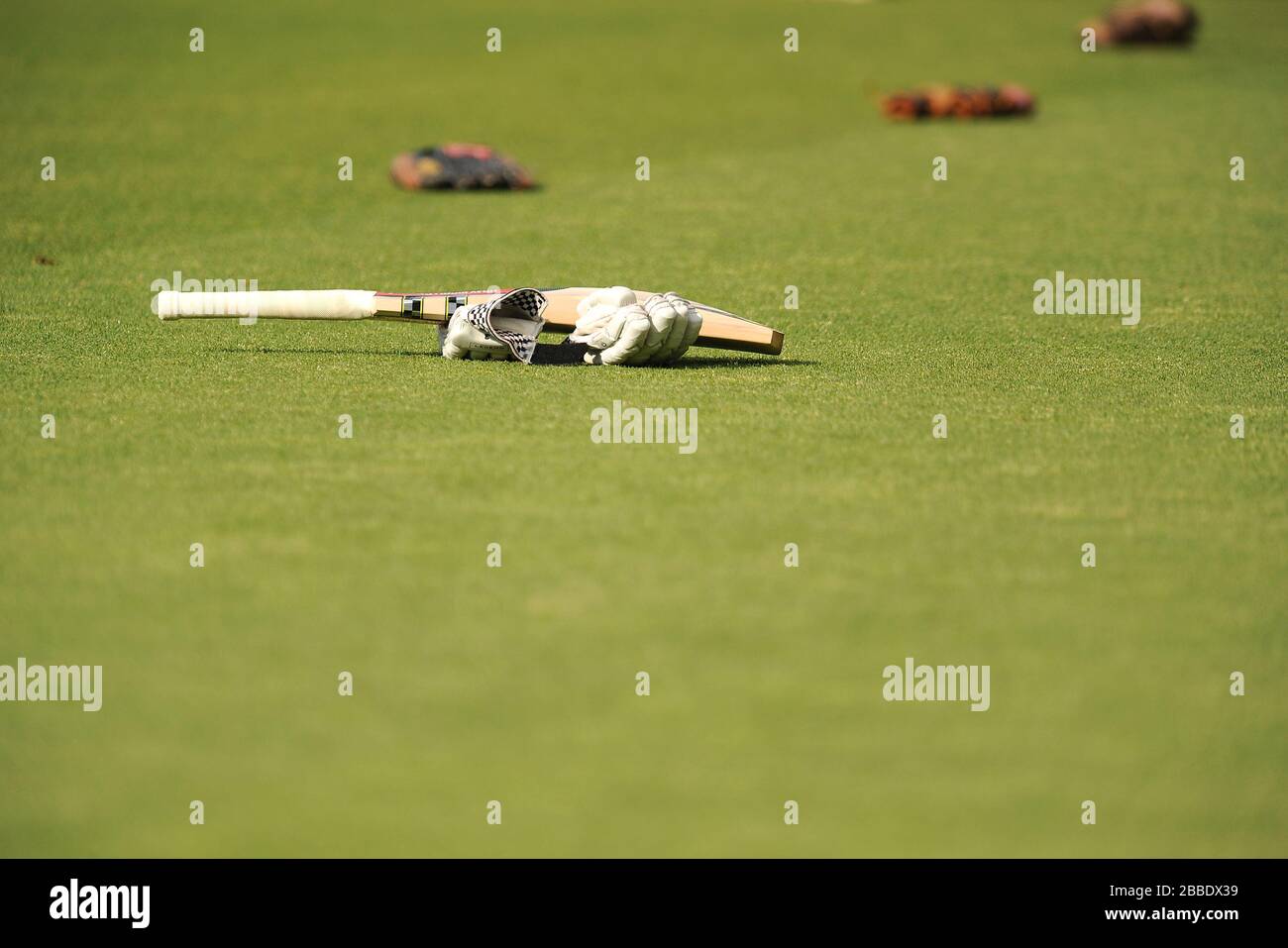 A cricket bat and gloves during warm up Stock Photo - Alamy