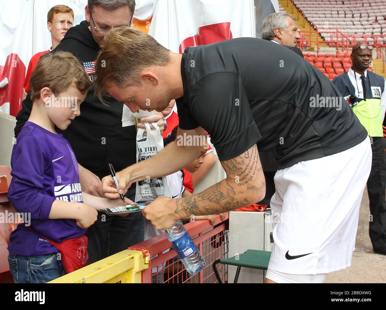 Charlton Athletic's Danny Green (right) signs an autograph for a young ...