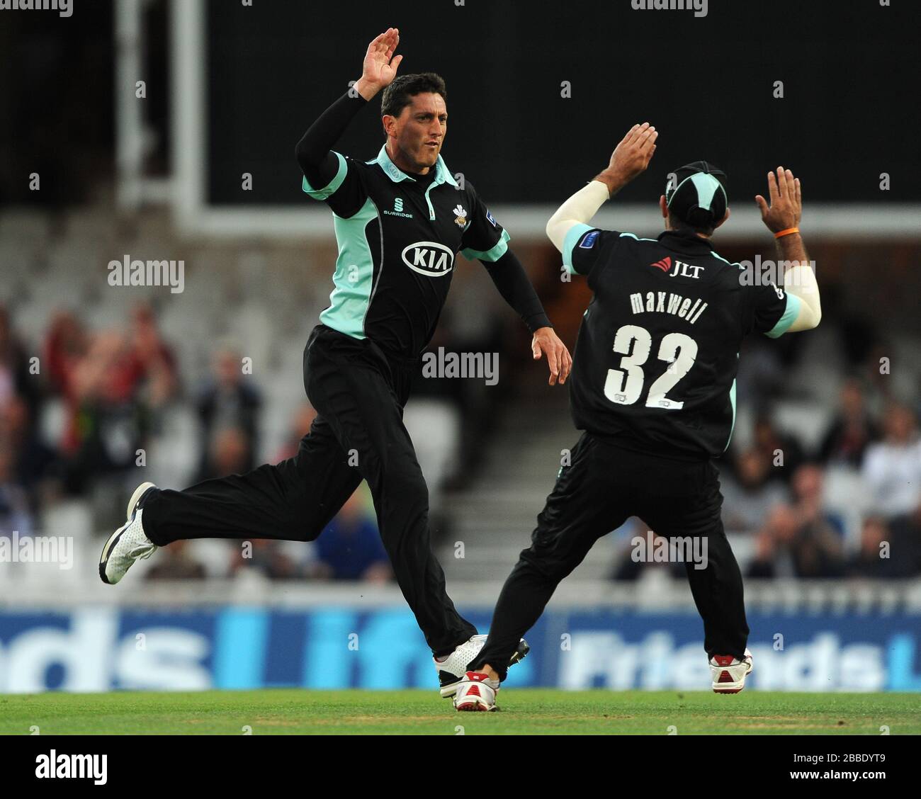 Surrey's Jon Lewis (left) celebrates with Glenn Maxwell after taking ...