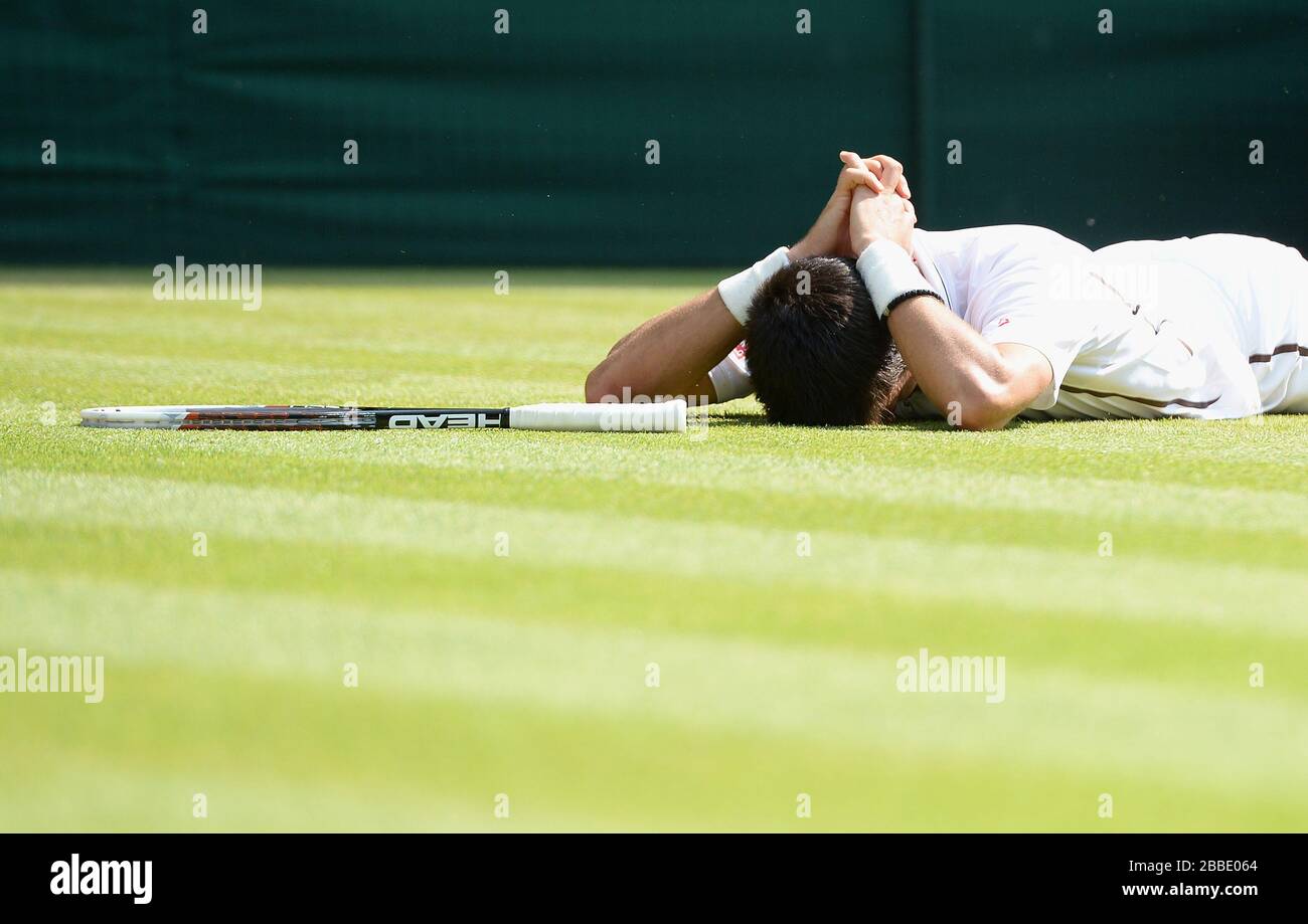Serbia's Novak Djokovic reacts on the floor after reaching for a shot ...