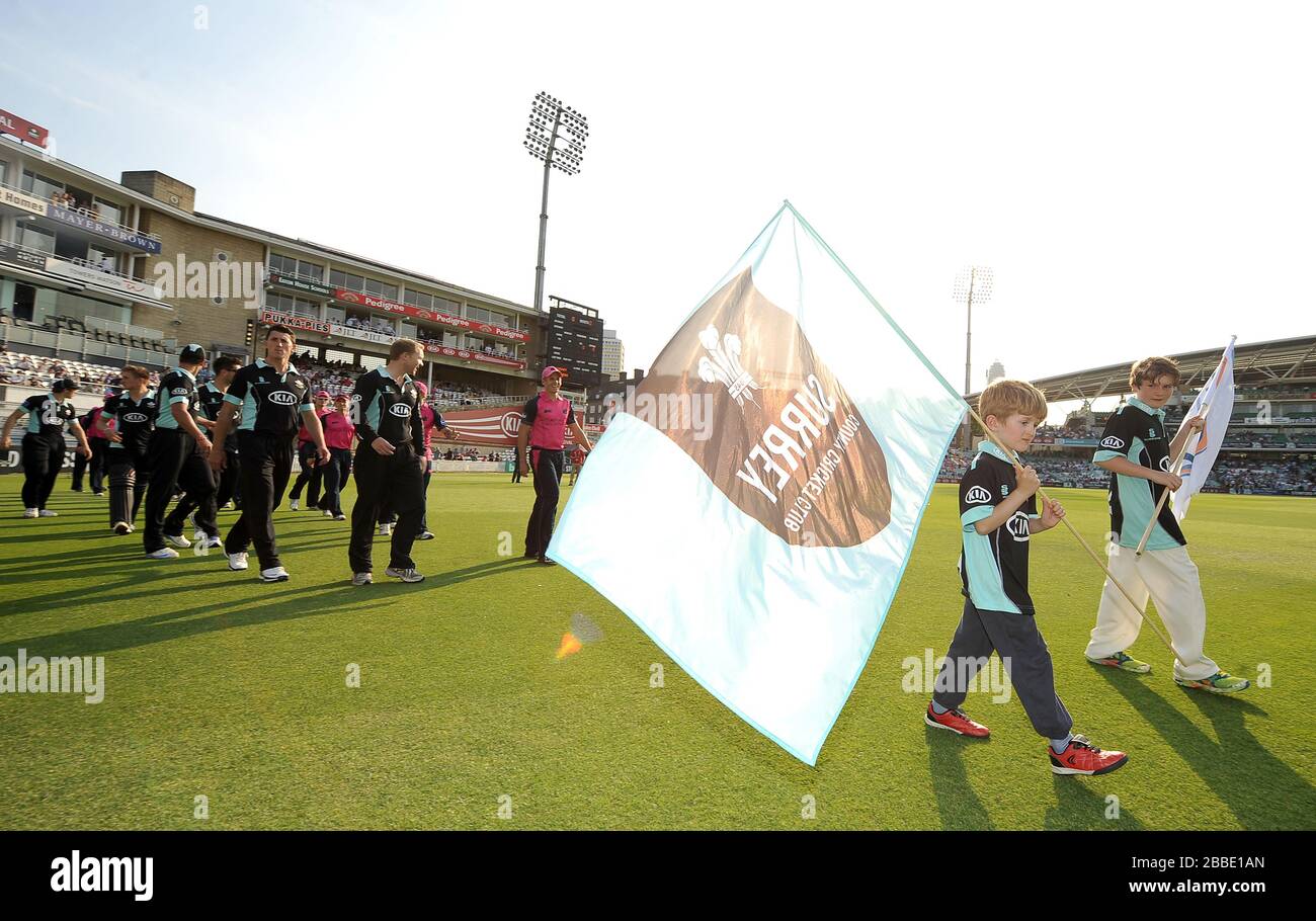 Surrey mascots lead out the players holding flags at the Kia Oval ...